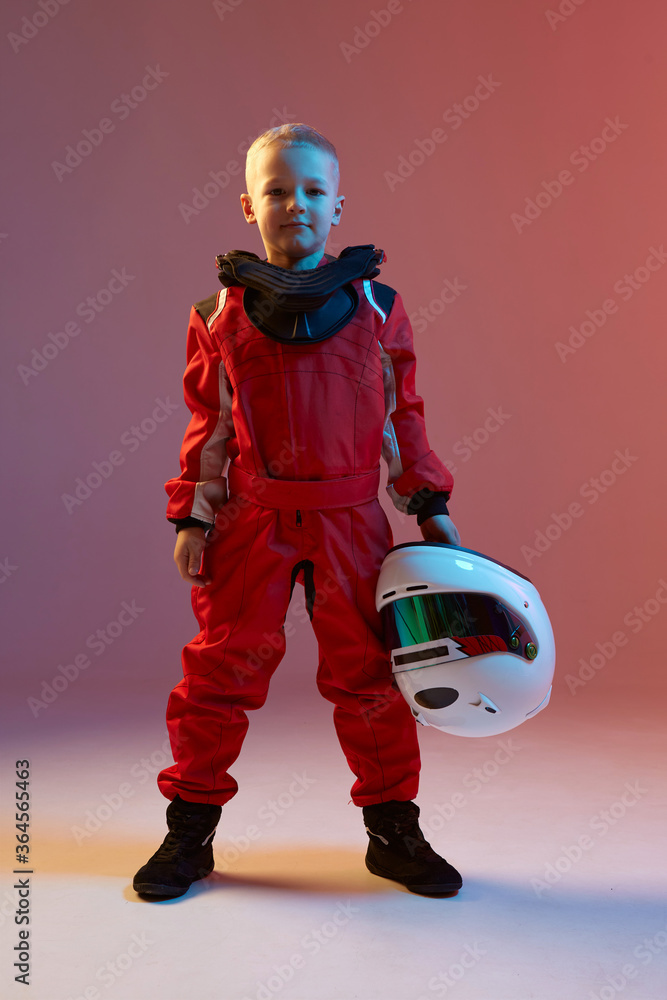 Cool boy child racer with helmet, standing in neon light. Kart racing ...