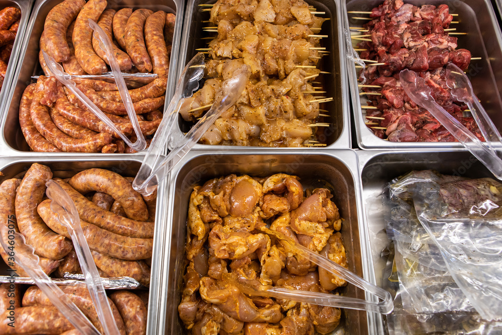 Various fresh meat products on butcher display refrigerator in bistro ...