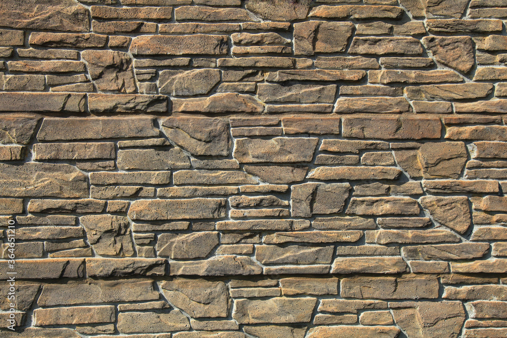 Beige-colored decorative stone wall, texture, background. Tan or light ...