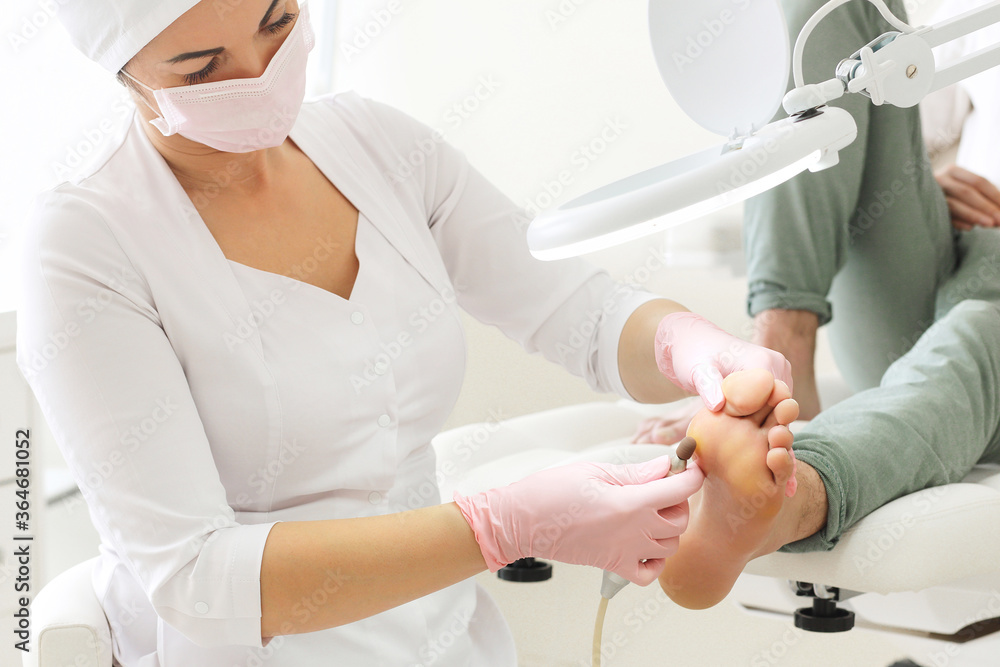 Patient on medical pedicure procedure, visiting podiatrist.Professional ...