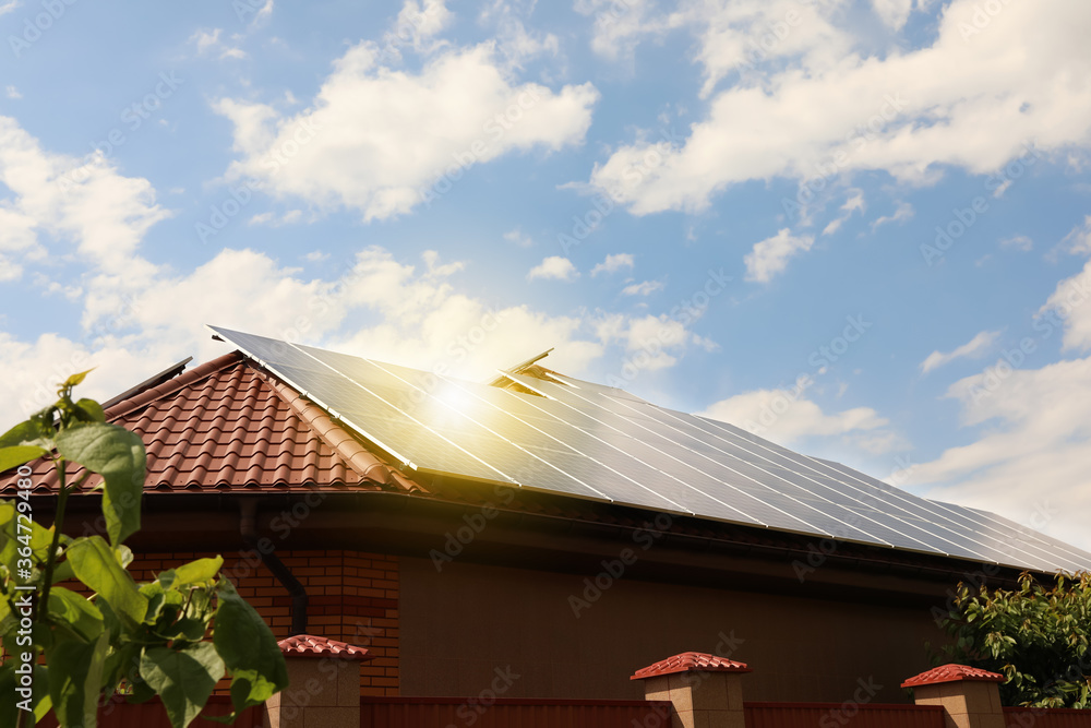 Building with installed solar panels on roof. Alternative energy source ...