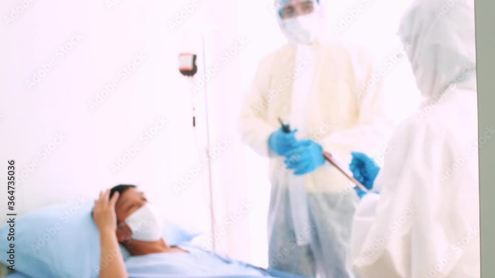 The doctor takes care a sick patient, coughing from coronavirus on ...