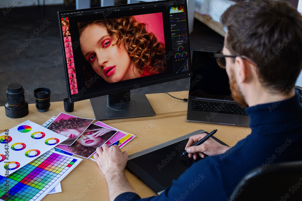 Retouching images in special program.Portrait of graphic designer ...