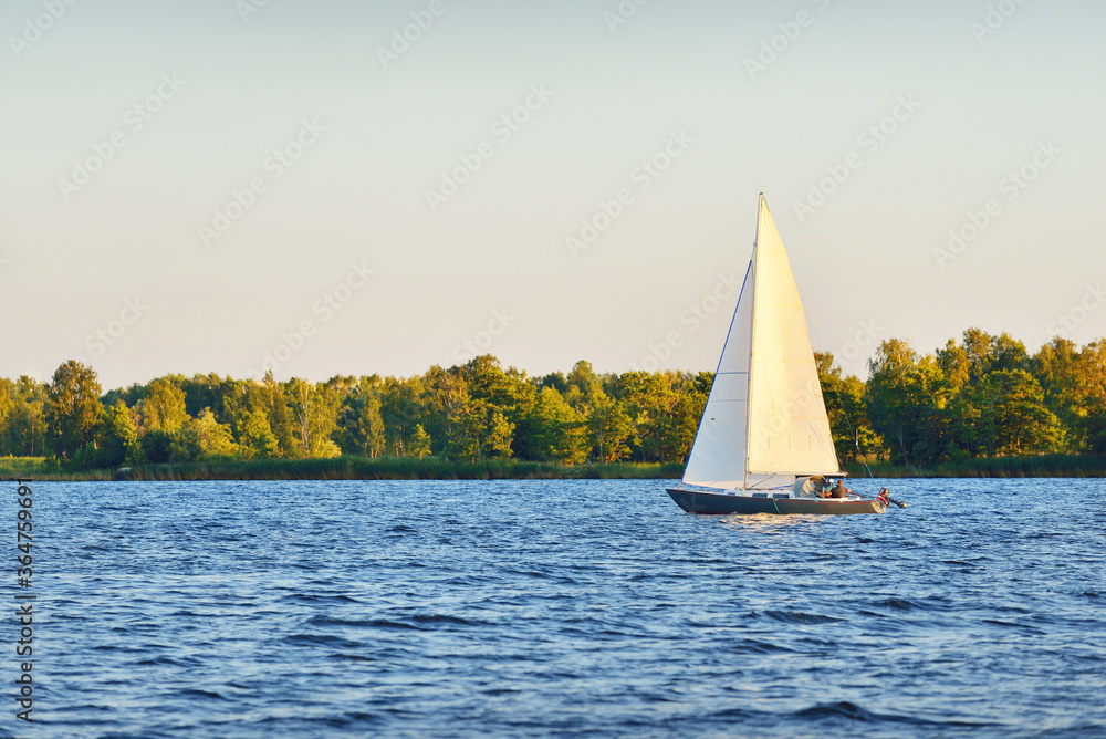 Sloop rigged yacht sailing in Riga bay at sunset. Baltic sea, Latvia ...
