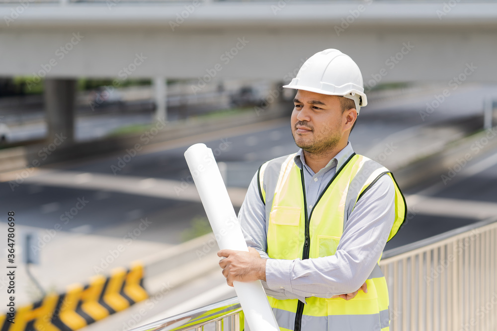 Portrait engineer handsome man or architect looking construction with ...
