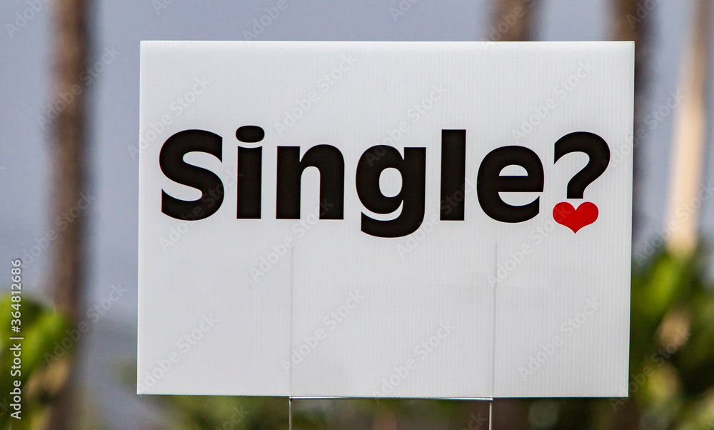 Sign with the word SINGLE and a question mark with a heart with palm ...