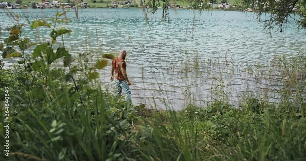Man throwing stone in the river spending his summer vacation in the ...