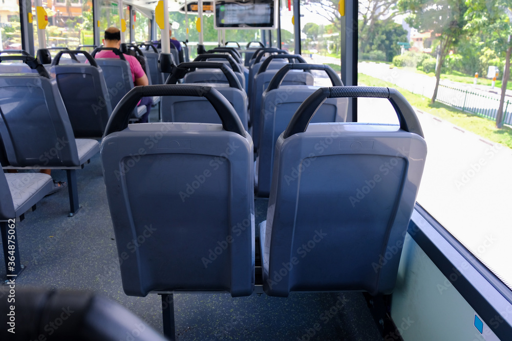 Back view of bus seats on double decker bus. Blank advertising space ...