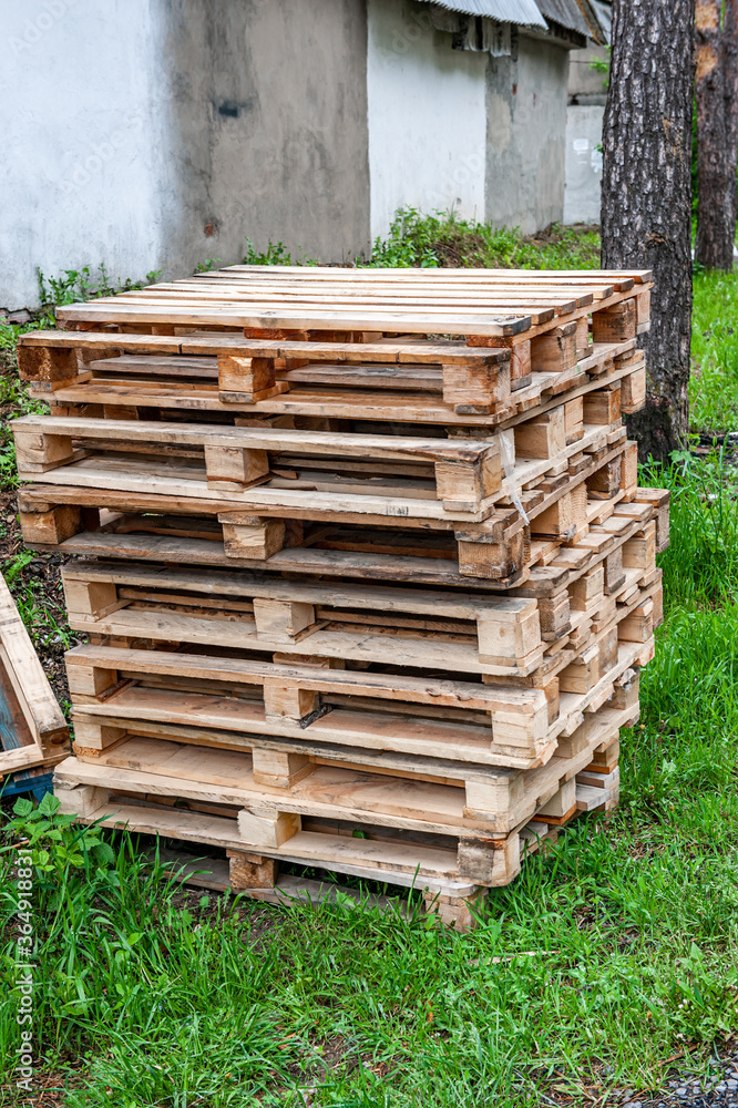 Stacked wooden pallets are stacked on the streets outside the premises ...