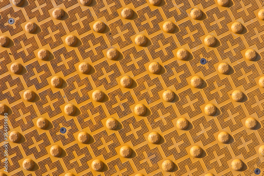Closeup of yellow geometric pattern of micro-pyramids in cruciform ...