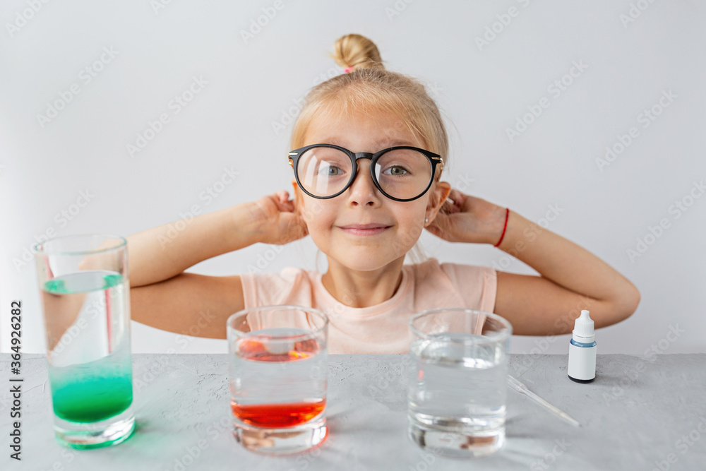 cute little girl six years old doing laboratory experiment with ...