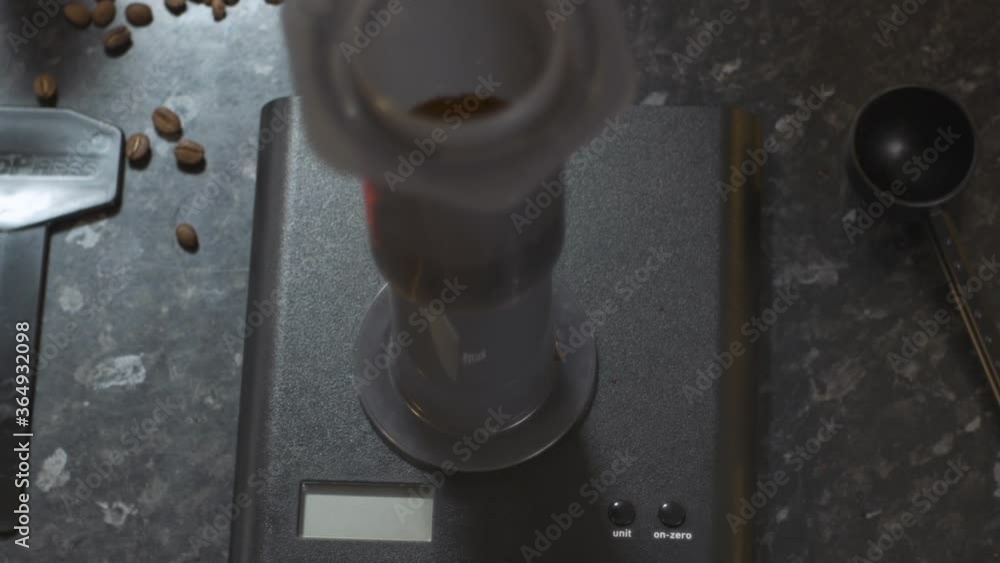 Coffee device, pre-infusion coffee sat on kitchen scales. Pouring ...