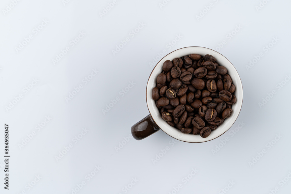 Java coffee beans, a mug filled with coffee beans, directly above photo ...