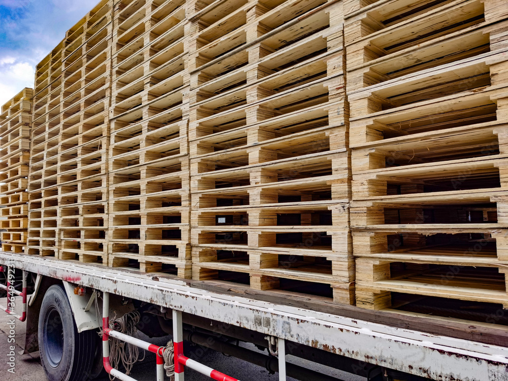 Worker driving forklift to loading and unloading wooden pallets from ...