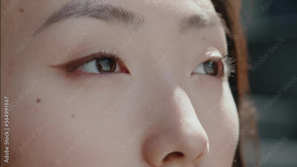 Gentle and beautiful young asian chinese woman opening eyes and looking ...