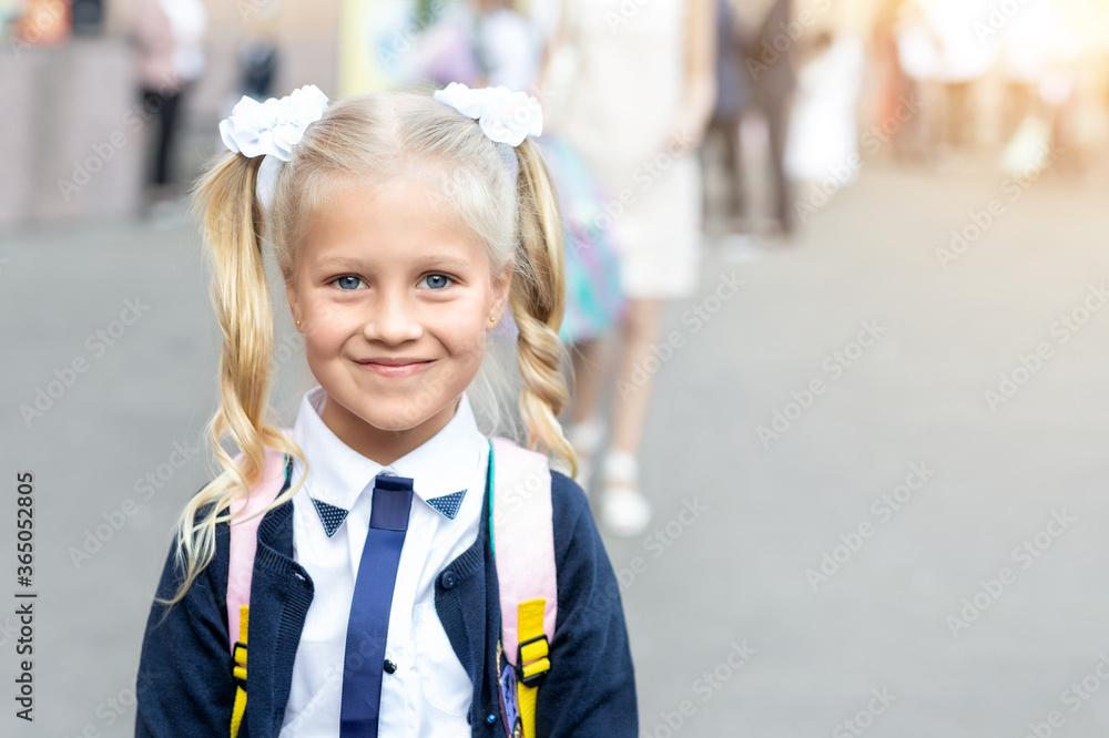 Portrait of cute adorable little caucasian school girl with funny blond ...