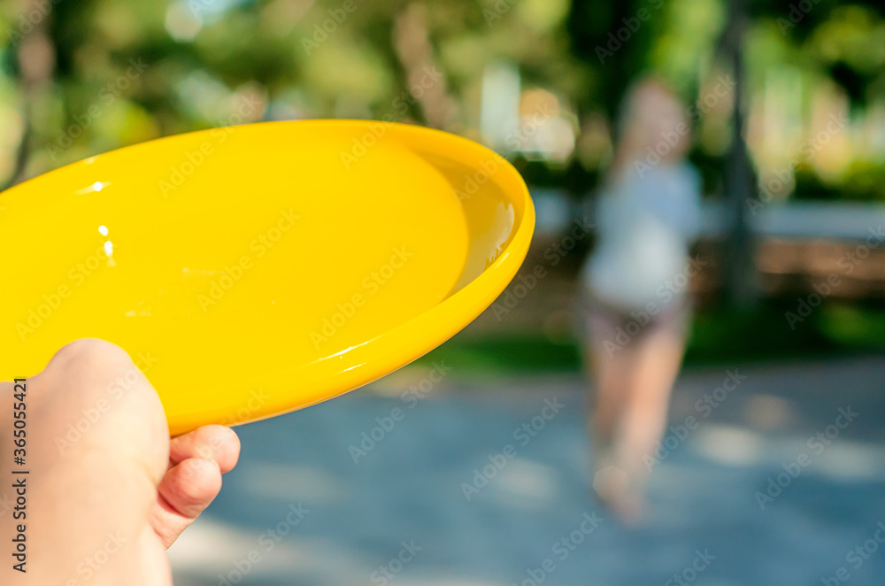 Yellow flying disc toy in hand playing on nature park background Stock ...