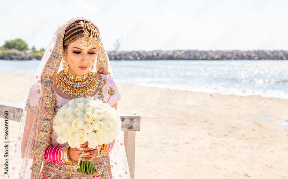 Beautiful female model wearing traditional Sikh wedding attire as she ...