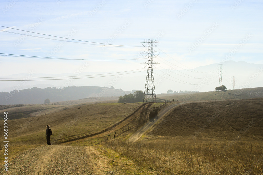 Photo & Art Print person hiking backroads next to high voltage power ...