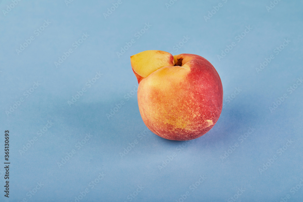 An ugly fruit or vegetable. Very ugly peach mutant on blue background ...