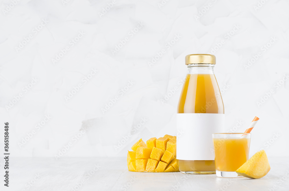 Yellow mango juice in glass bottle mock up with blank label, straw ...