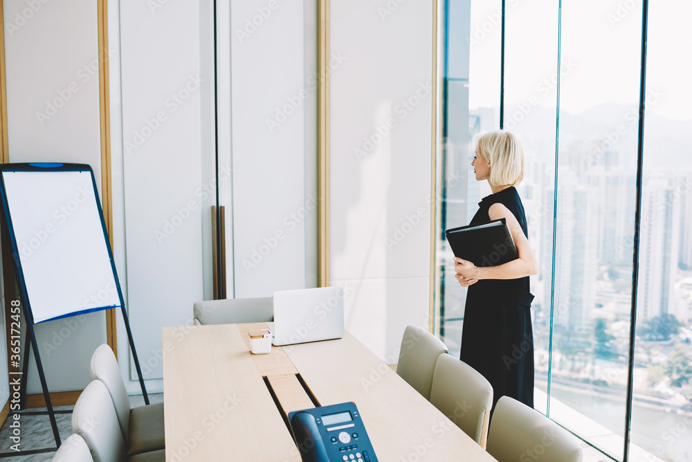 Young smart woman managing director with paper documents is hand is ...