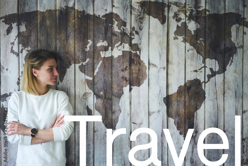 Young female with crossed arms standing against world map with seven ...