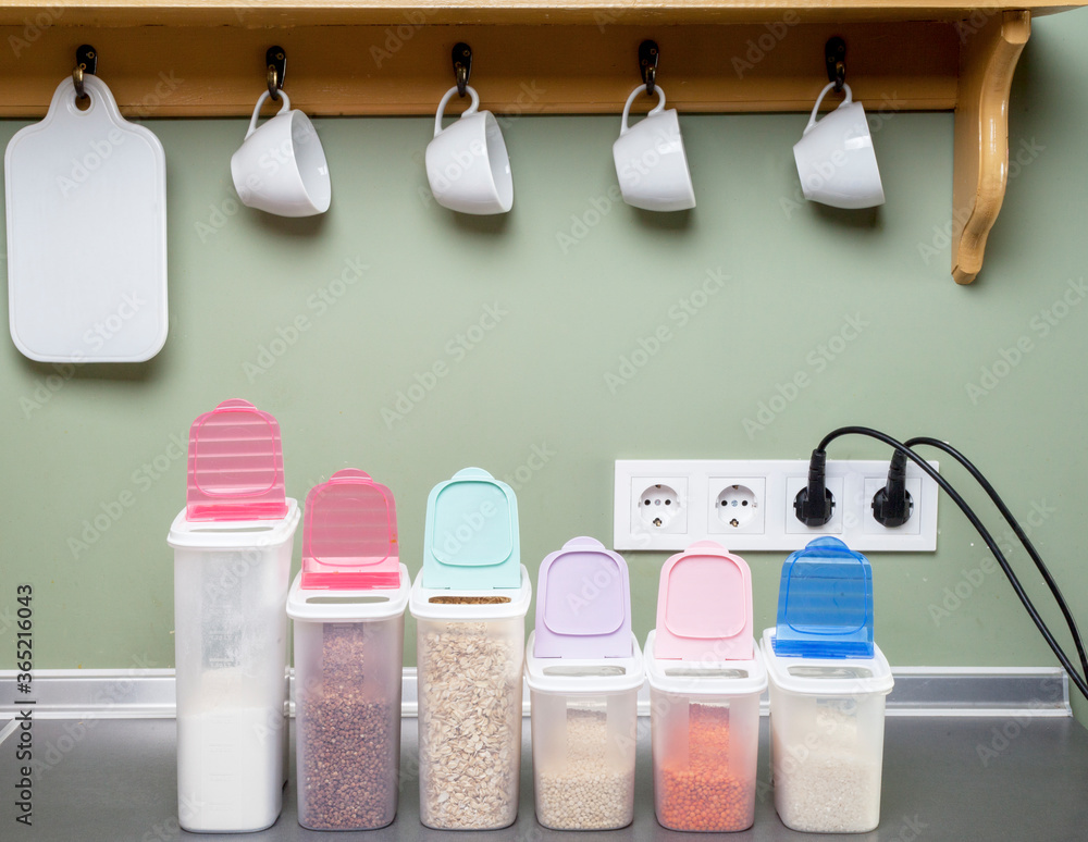 Filled kitchen pantry with food - lentils, buckwheat, rice, couscous ...