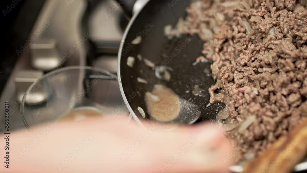 Removing the liquid/juice from frying ground beef. Concept of cooking ...