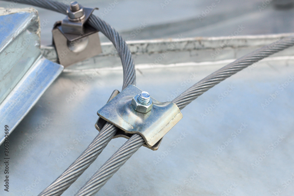 Fixing an aluminum ground wire on the galvanized roof of the building ...