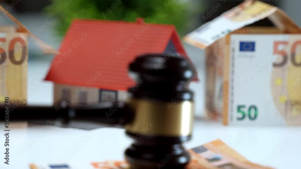 Real estate auction according to the law. Stack of money falling on the ...