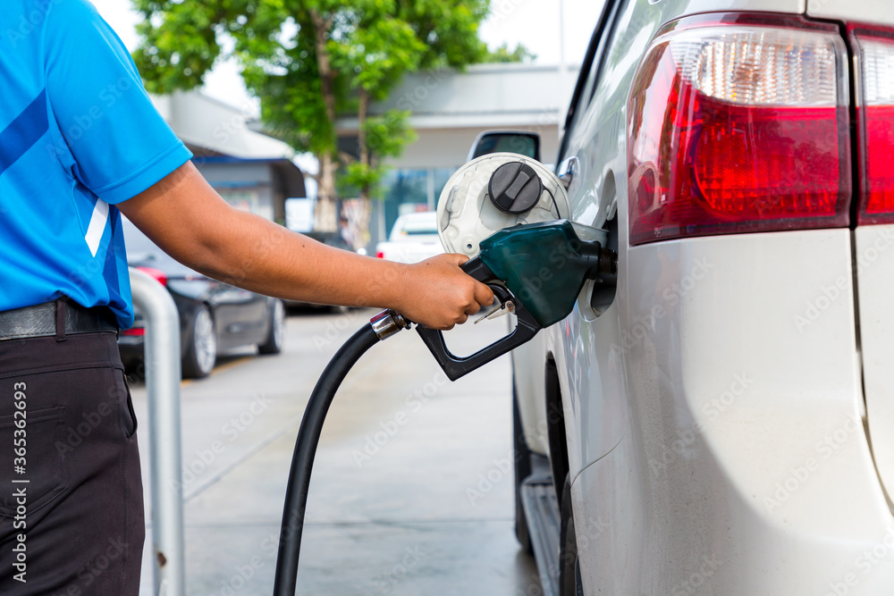 Hand Man Refill and filling Oil Gas Fuel at station. Gas station ...