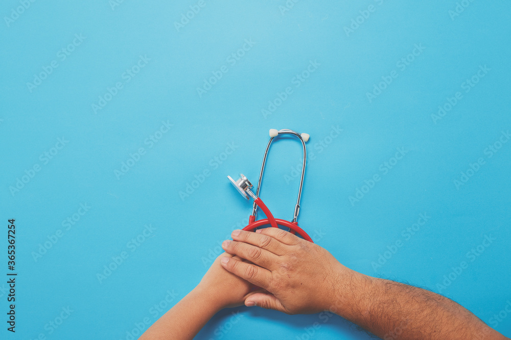 Adult and child hands holding red stethoscope Stock Photo | Adobe Stock