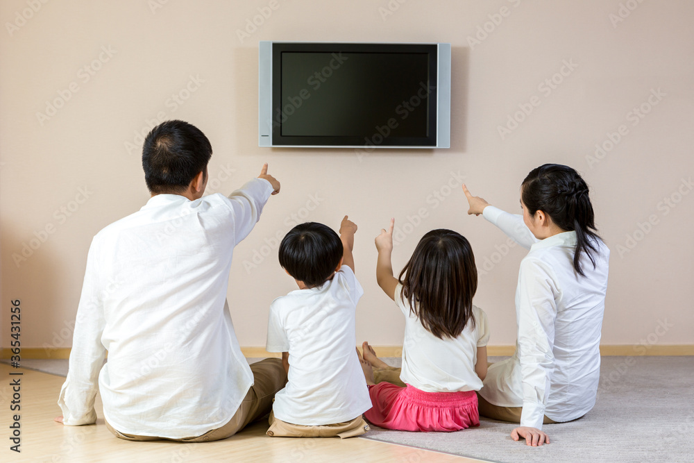 Happy family watching TV at home Stock Photo | Adobe Stock