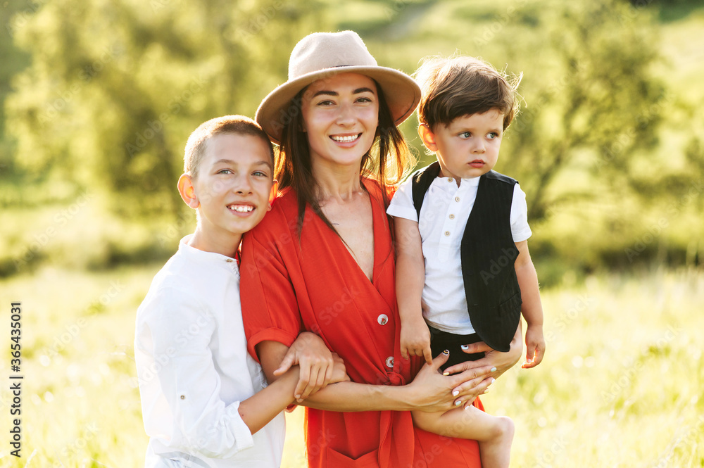 Young mom with two sons on nature Stock Photo | Adobe Stock