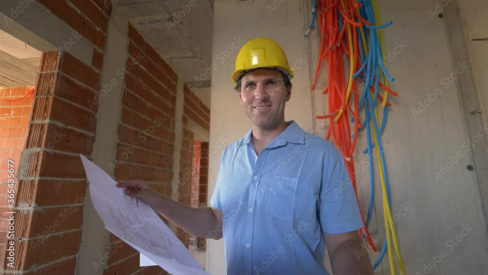 SLOW MOTION, CLOSE UP, PORTRAIT: Cheerful contractor smiles after ...