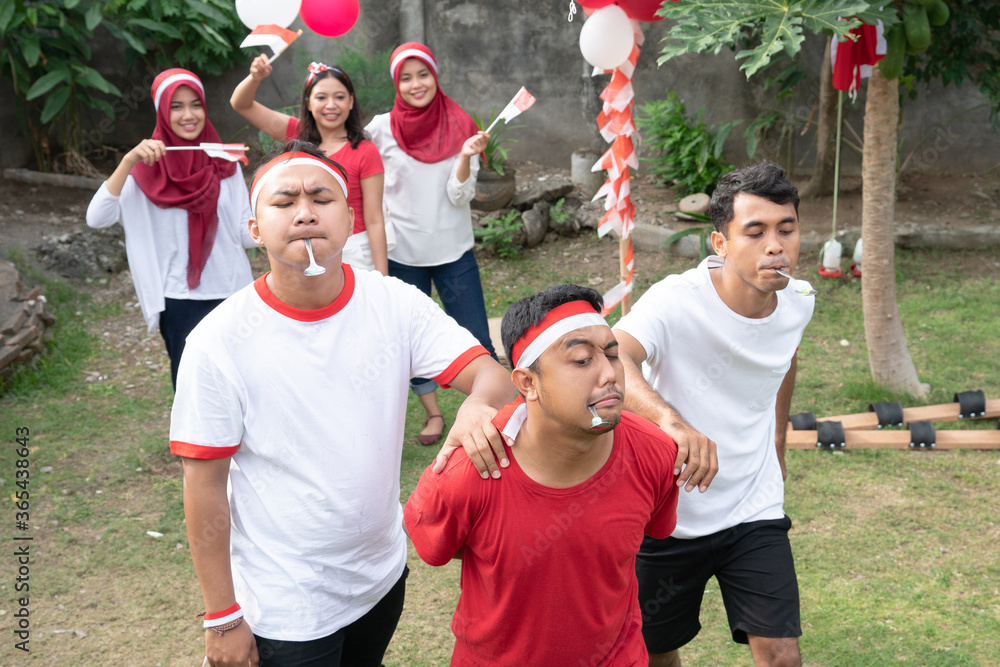 participants compete in the marble and spoon race with the audience supports the celebration of ...