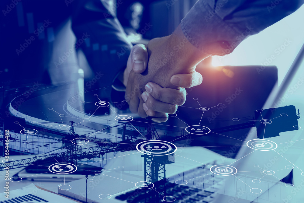 Double exposure of business handshake with digital technology ...