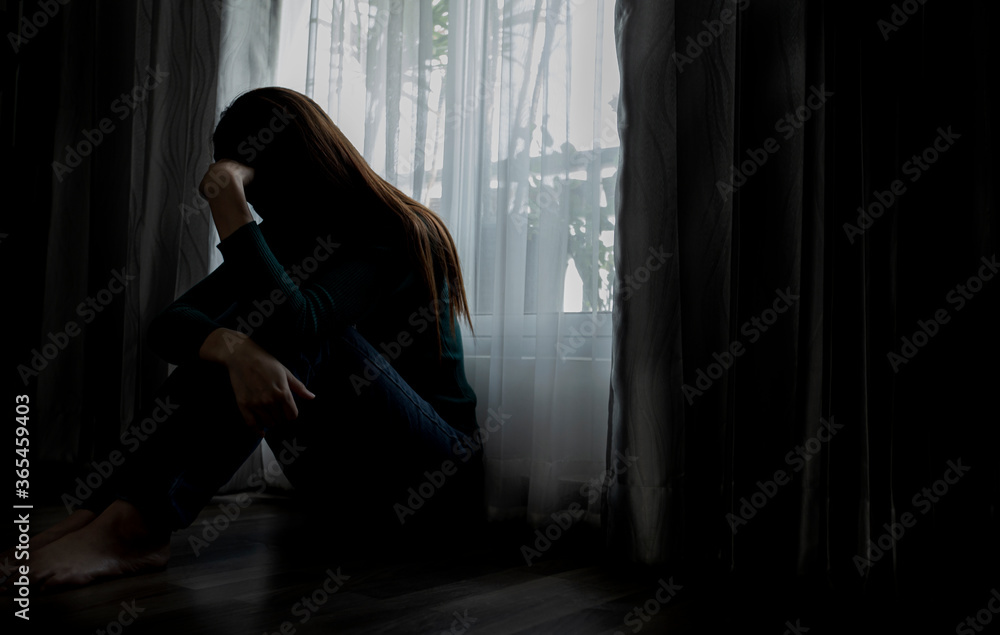 Sad young woman sitting on the bed in the bedroom, People with ...