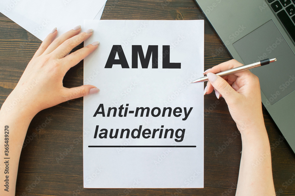 Paper with Anti-money laundering AML on a table Stock Photo | Adobe Stock