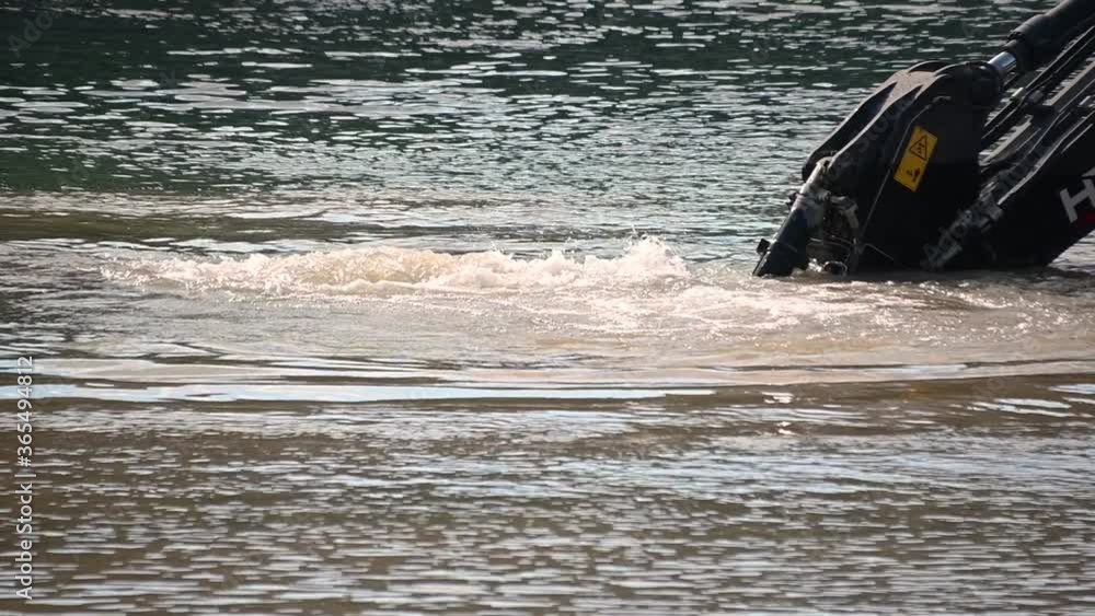Building construction site at the river bank. Excavator digging pebbles ...
