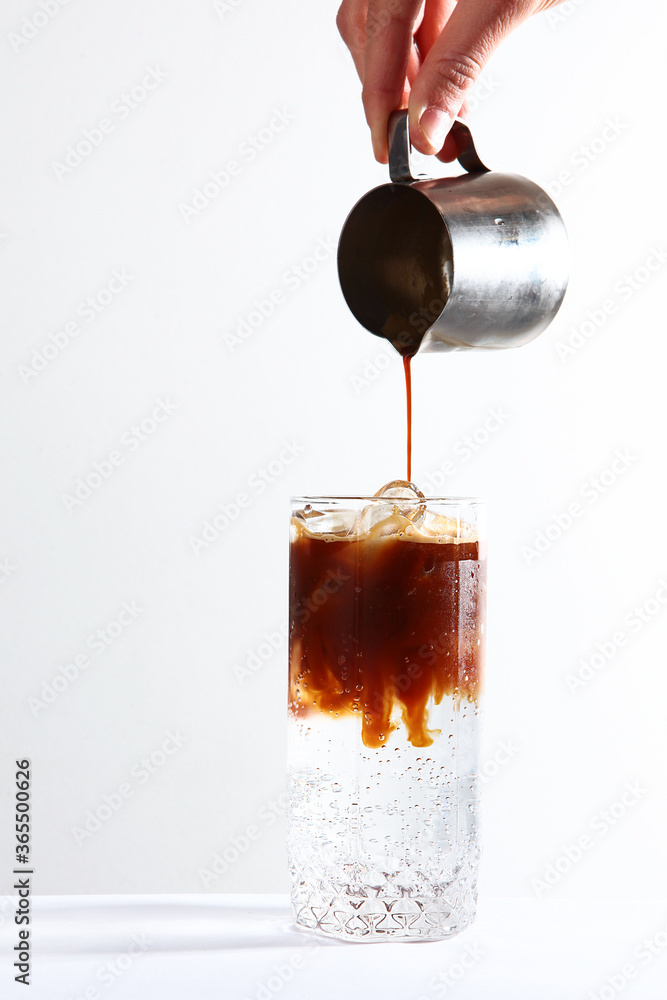 Soft drink based on coffee and mineral water. Coffee is poured into ice ...