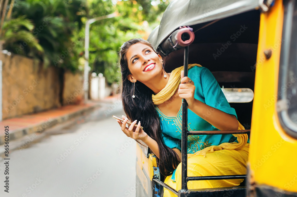 Pretty Indian woman in a auto rickshaw with phone Stock Photo | Adobe Stock