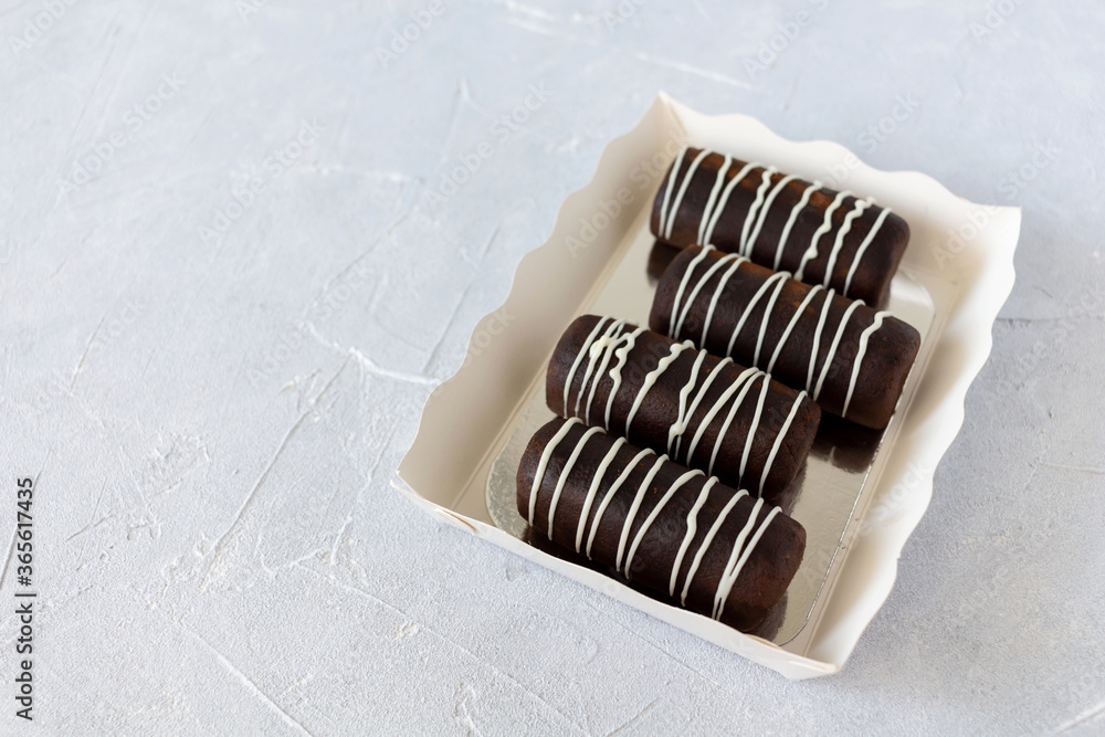 Chocolate rum balls cake decorated with white glaze on paper substrate ...