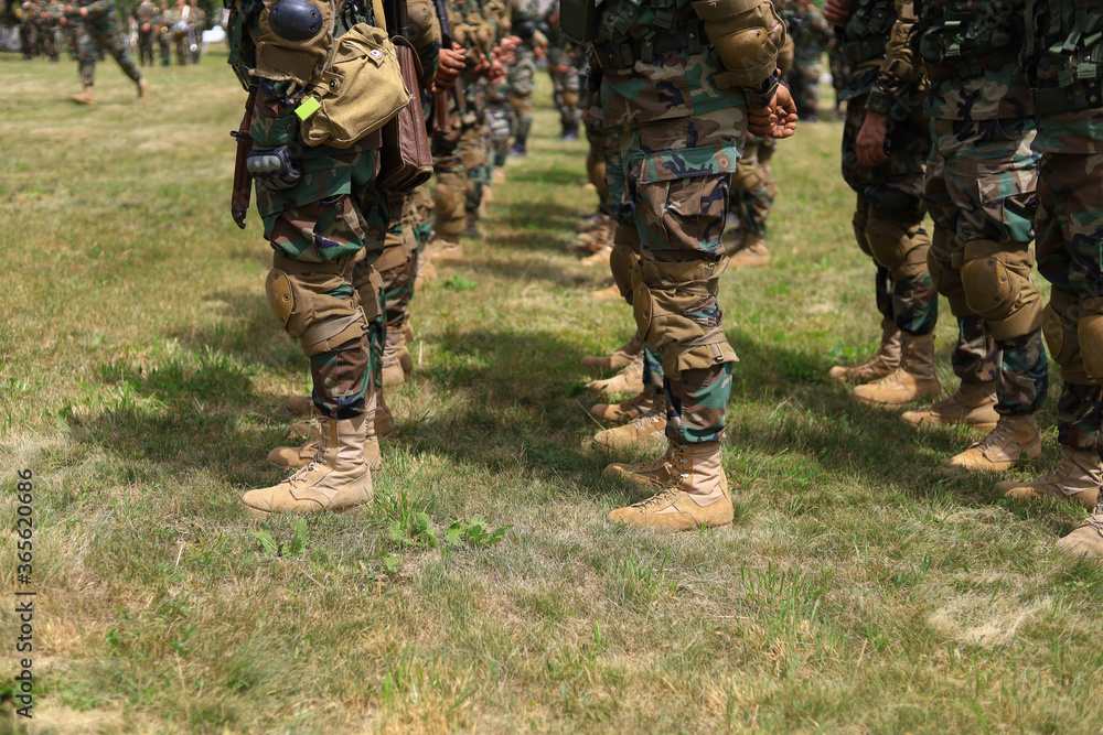 Legs of real soldiers in military boots and clothes standing in ...