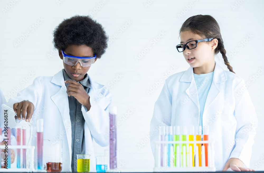 Kid in lab coat learning chemistry in school laboratory, Kid scientist ...
