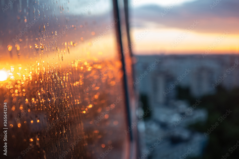 wet the window glass and the reflection of the sunset, the texture of ...