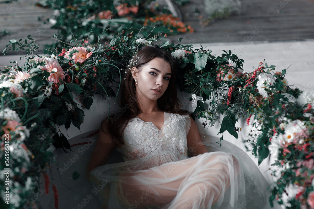 Beautiful pretty woman relaxing in bath with many flowers and green ...