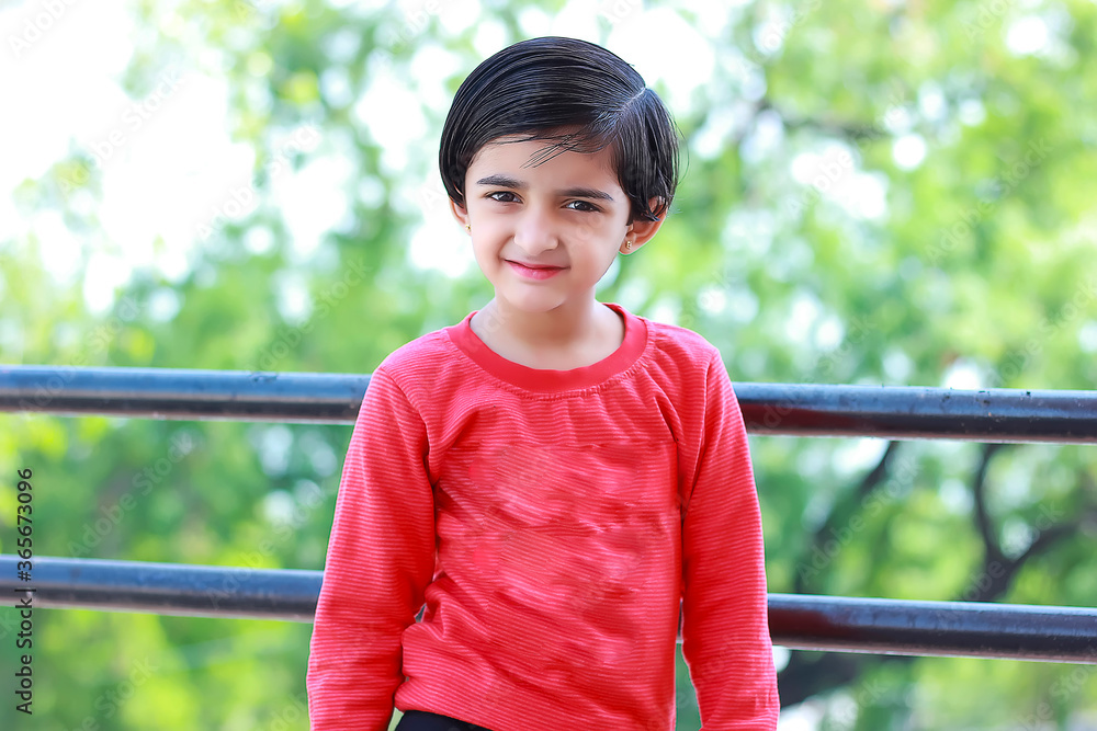 Cute Indian little girl at outdoor background Stock Photo | Adobe Stock