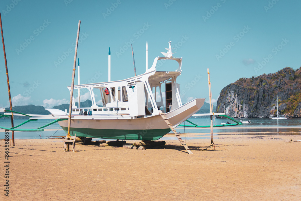 Traditional philippine boat called bangka on the beach, toned. Fishing ...